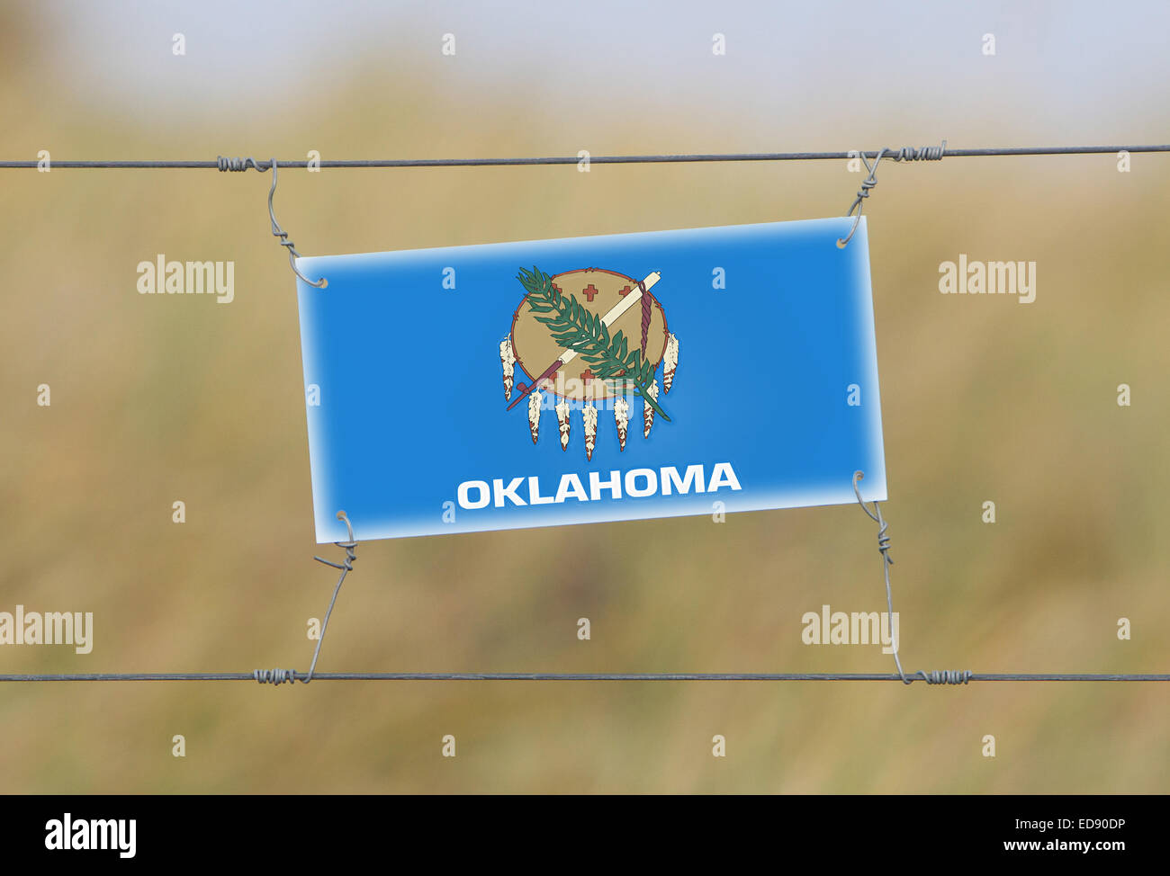 Border fence - Old plastic sign with a flag - Oklahoma Stock Photo - Alamy