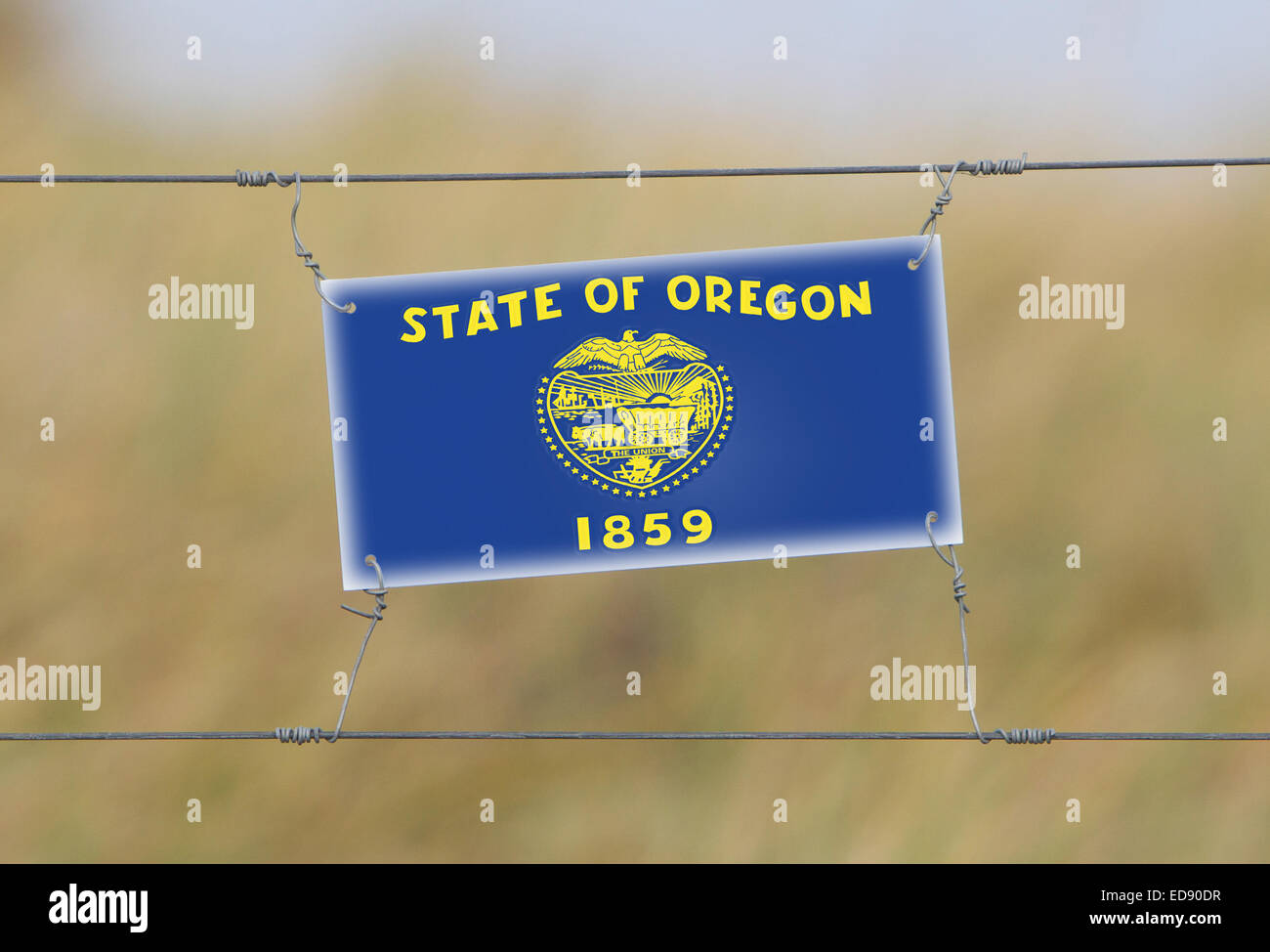 Border fence - Old plastic sign with a flag - Oregon Stock Photo - Alamy