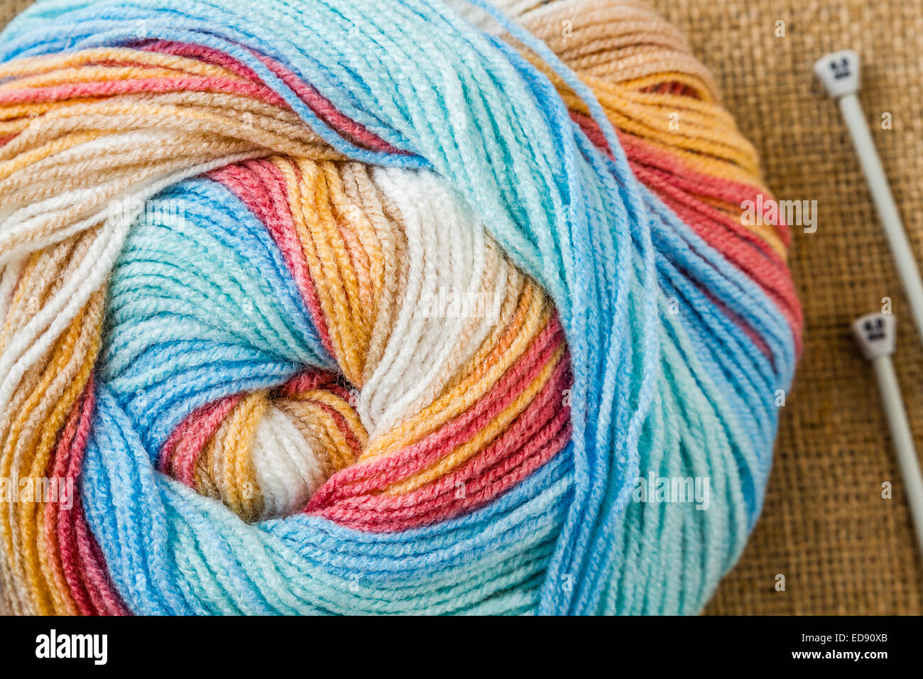 Colorful woolen knitting yarn on sack fabric Stock Photo - Alamy