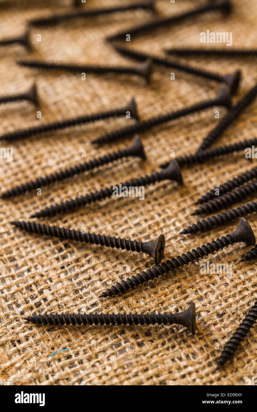 Group of used and old screws on sack fabric Stock Photo - Alamy