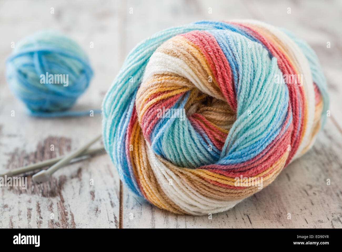 Colorful woolen knitting yarns on white wooden background Stock Photo ...