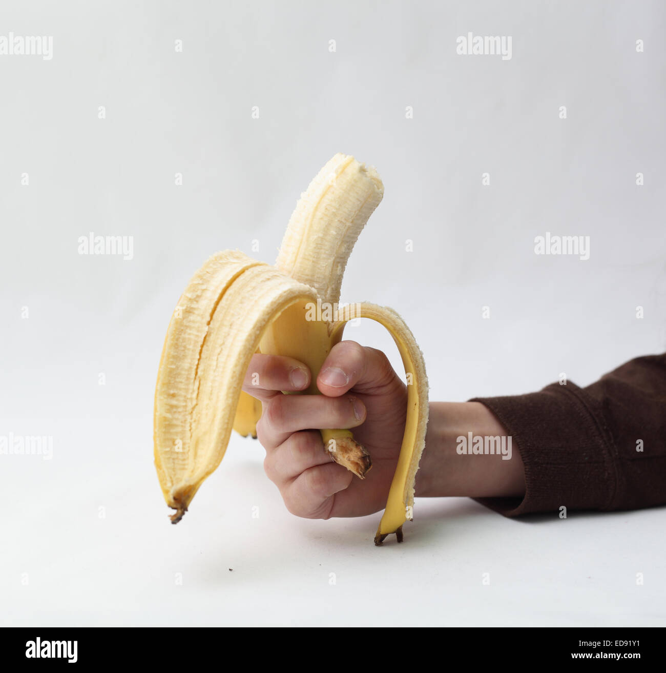 banana in hand on a white background Stock Photo - Alamy