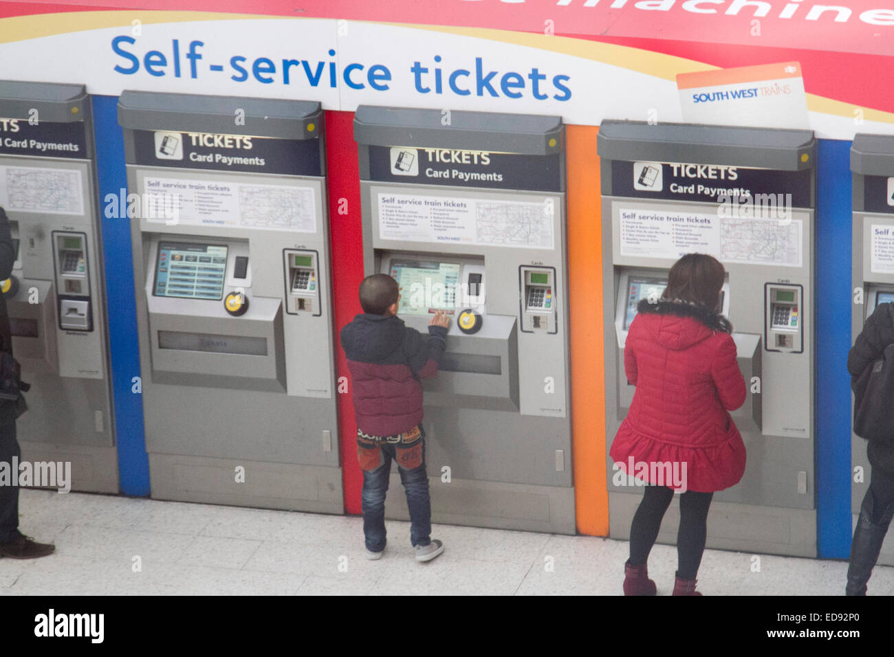 London, UK. 2nd January 2015. Passengers using self service ticket ...