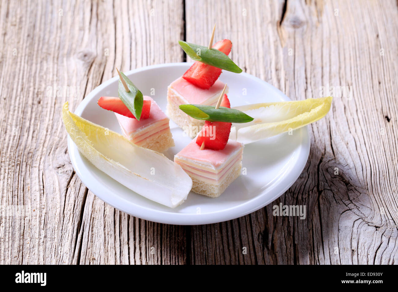 Ham and cheese canapes and endive leaves Stock Photo - Alamy