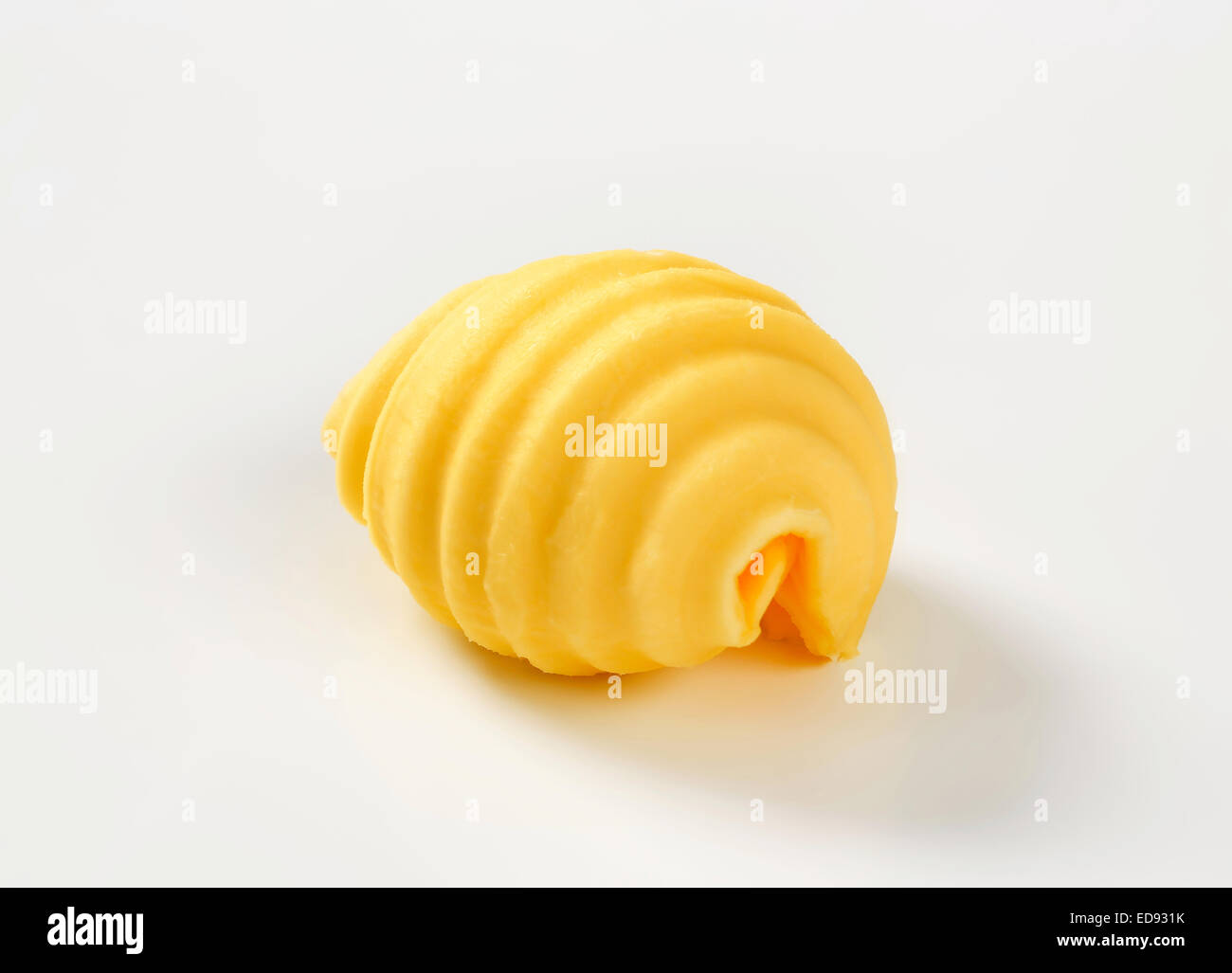 Studio shot of single butter curl Stock Photo - Alamy