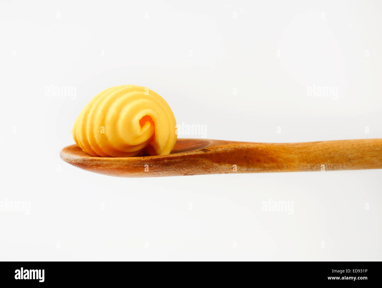 Butter curl on wooden spoon Stock Photo - Alamy