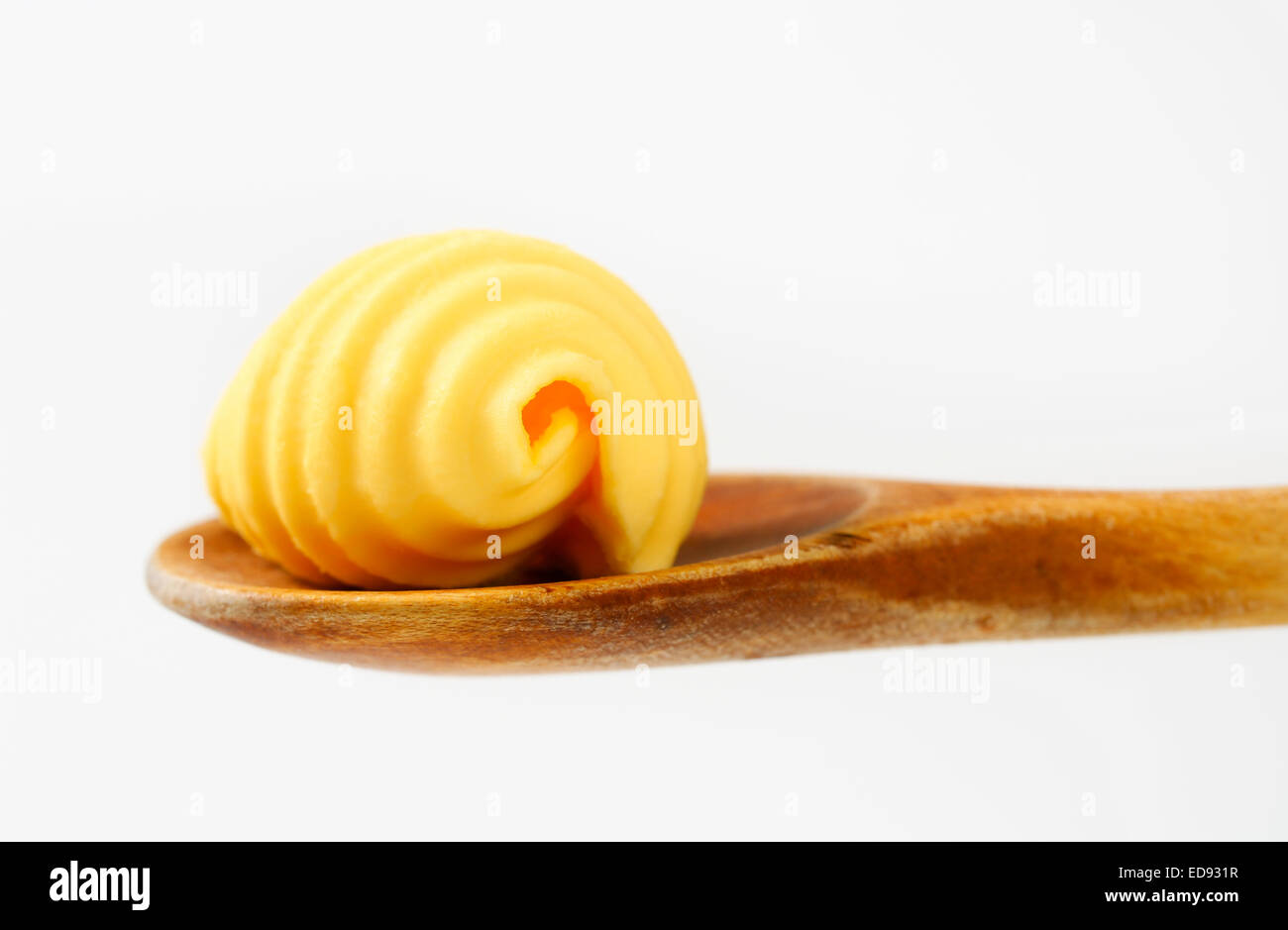 Butter curl on wooden spoon Stock Photo - Alamy