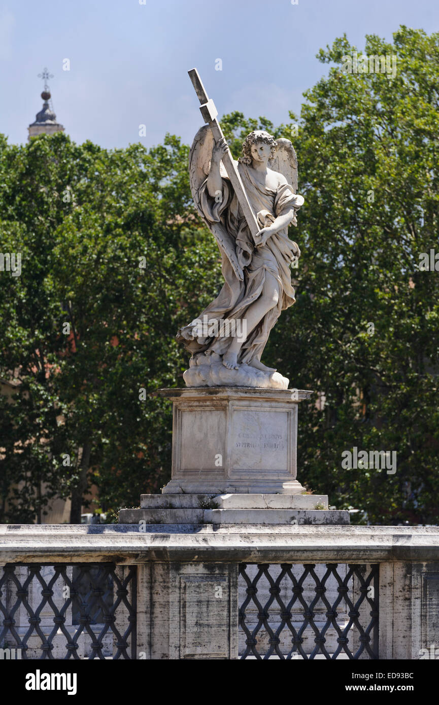 An Angel sculpture holding a cross from St Angelo bridge in City of ...