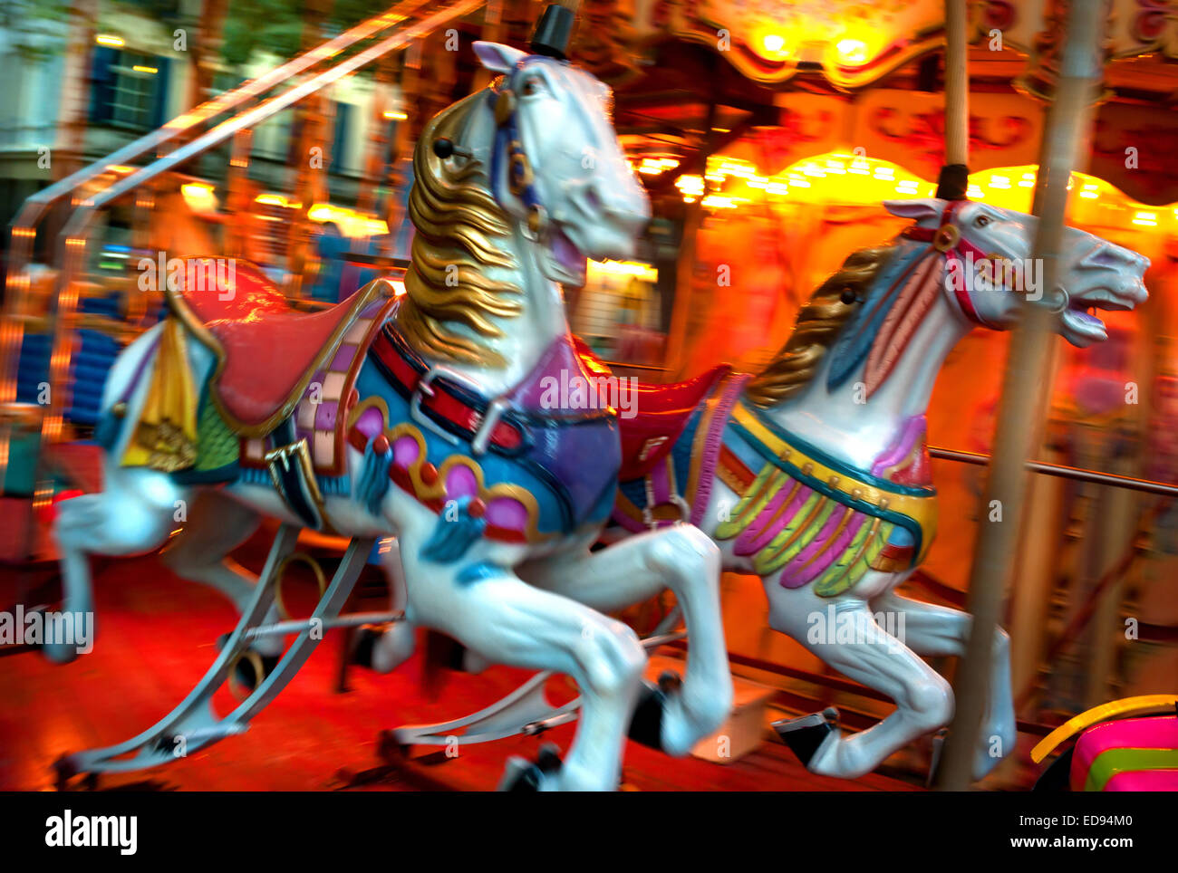 Bright coloured wooden carousel horses / Fairground ride Stock Photo ...