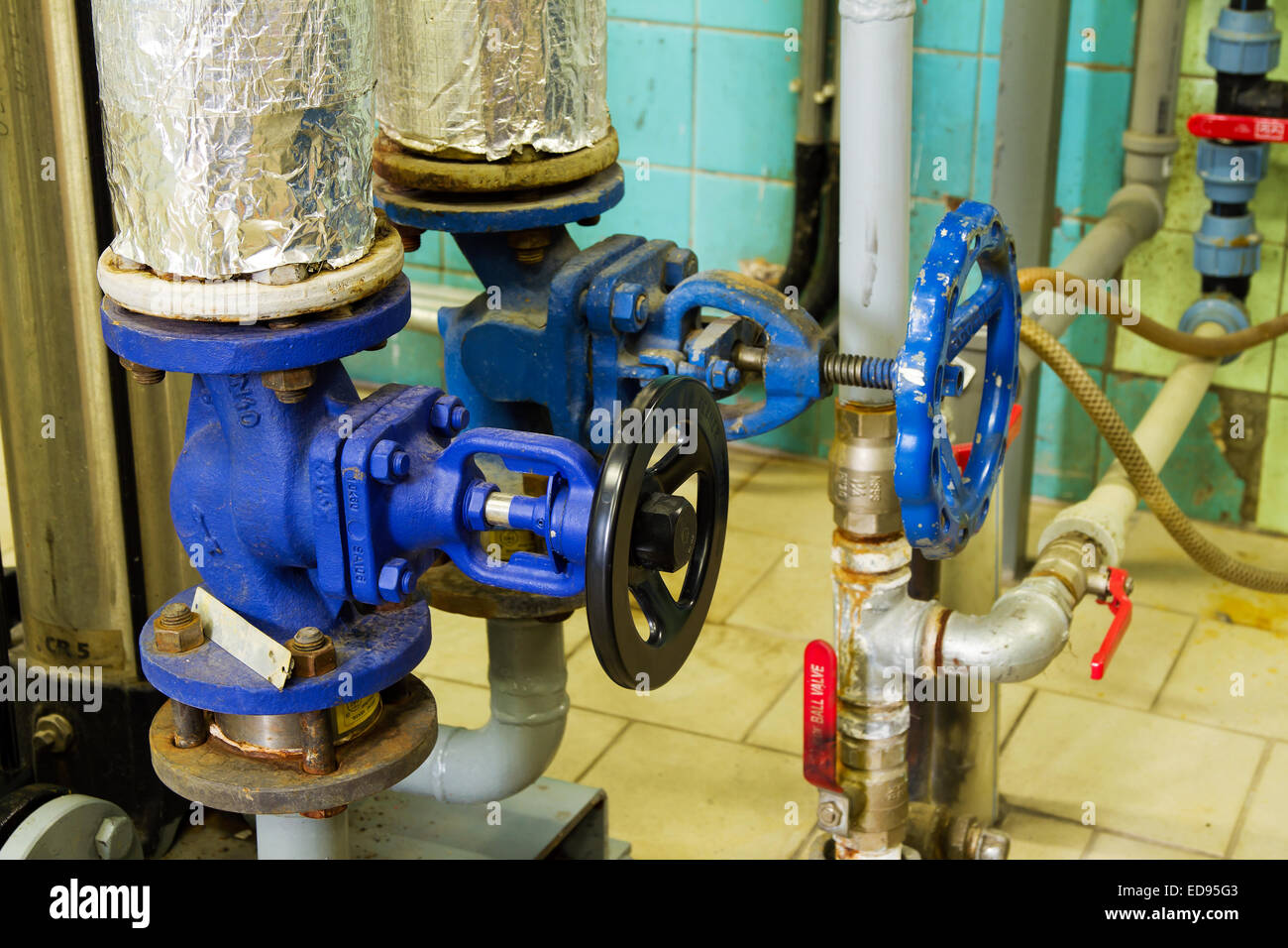 Closeup of pipes and faucet valves of heating system in a boiler room ...