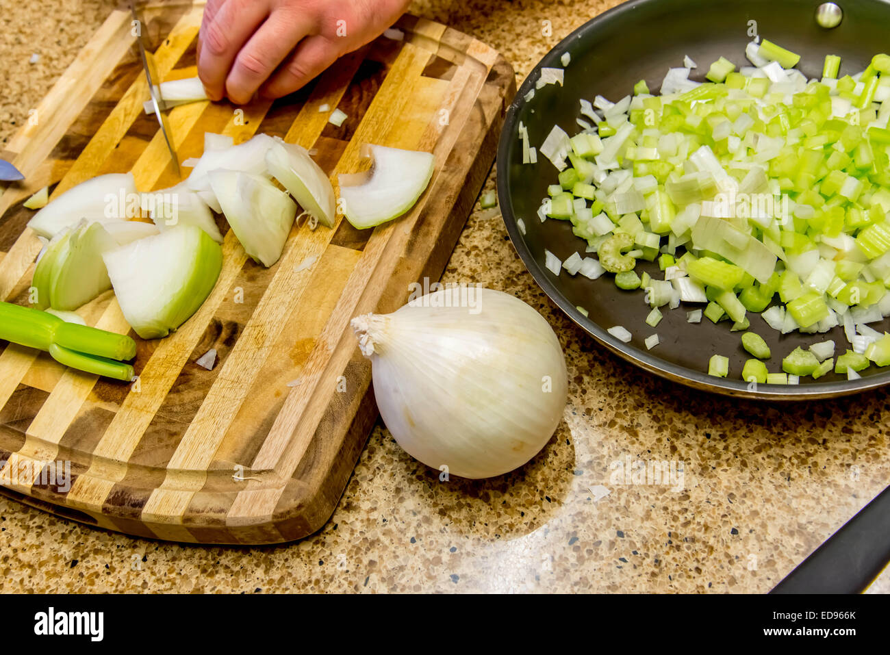 cook chopping onion on a cutting board Stock Photo - Alamy