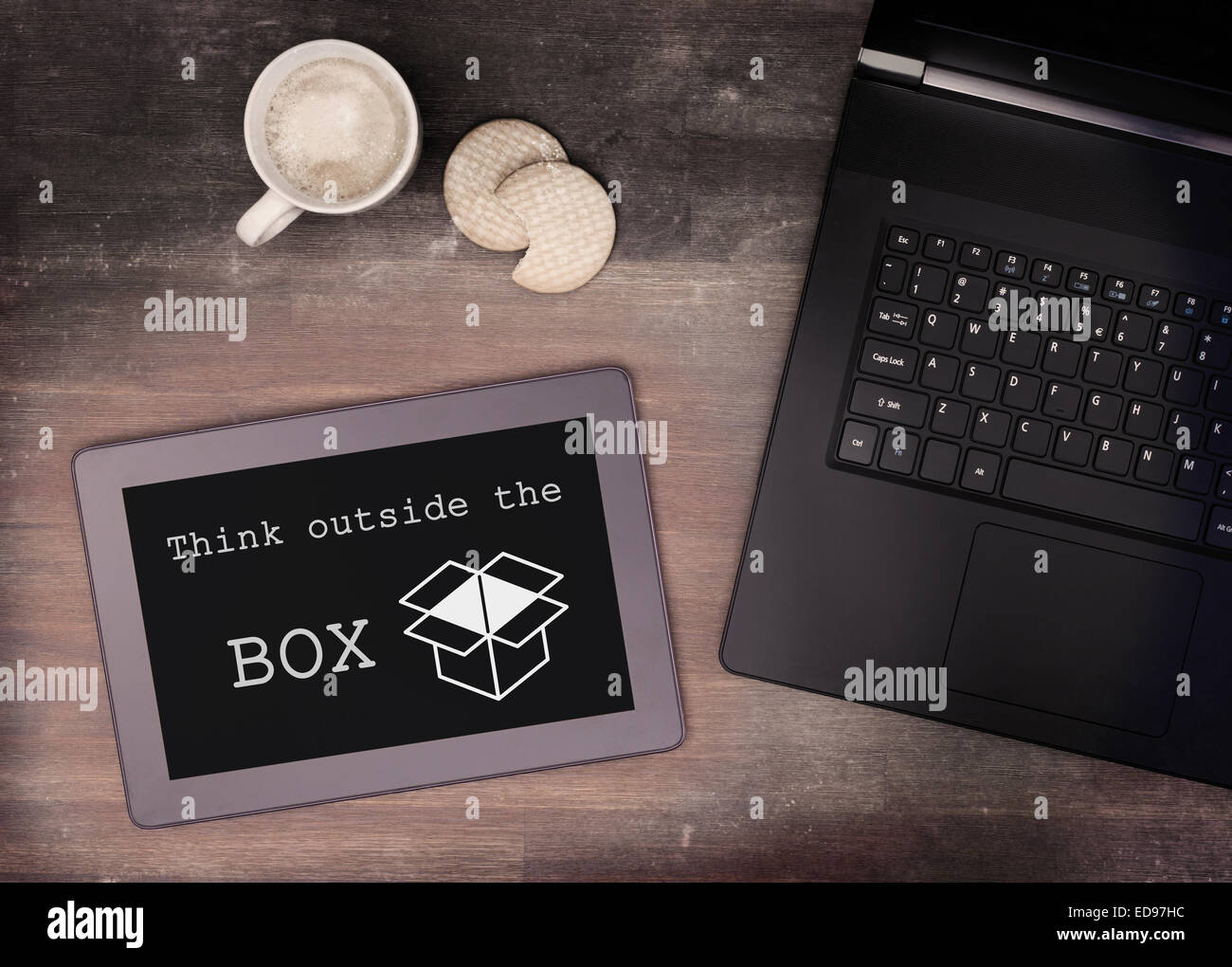 Tablet touch computer gadget on wooden table, think outside the box ...