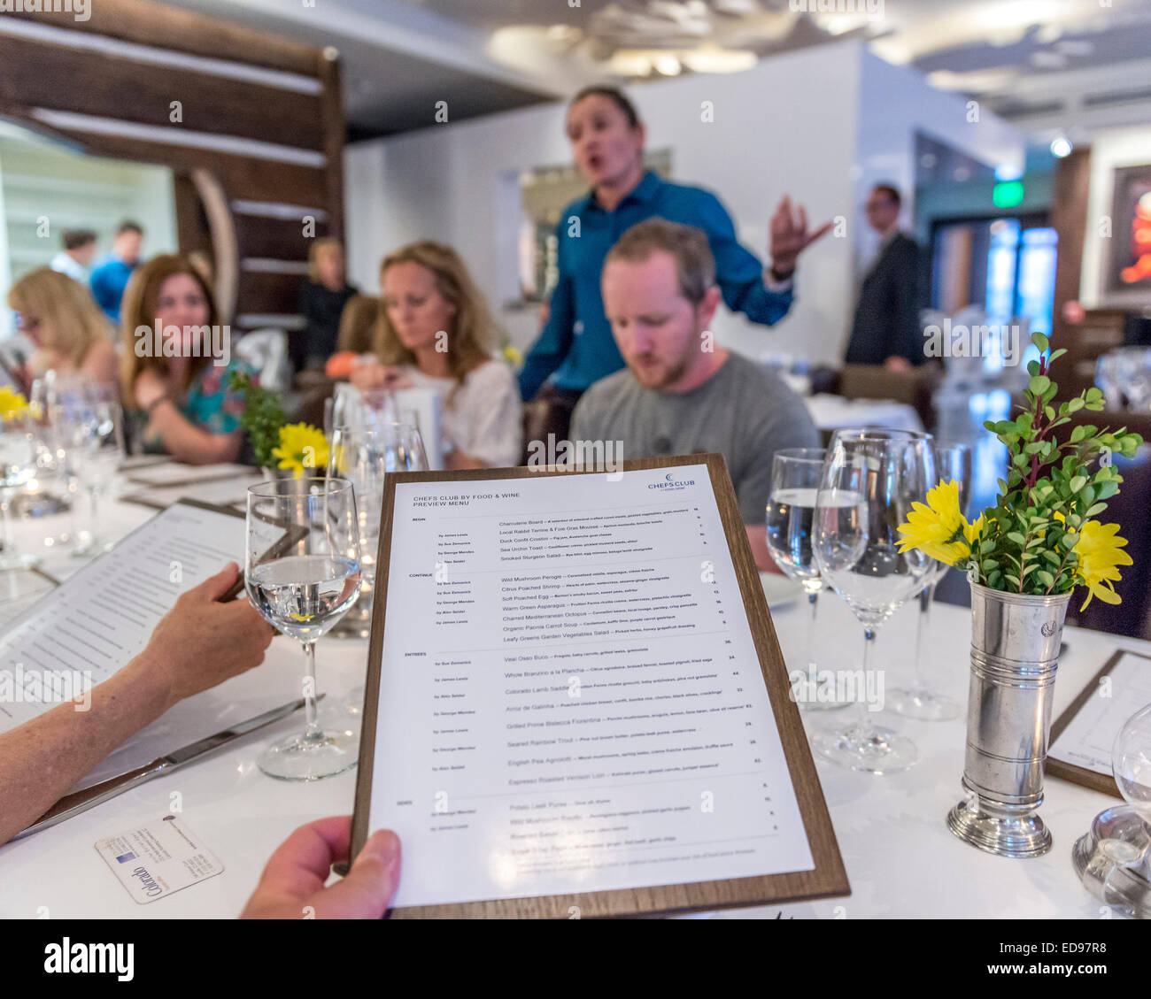 Diners at a restaurant table looking at the menu. Chefs Club. Aspen ...