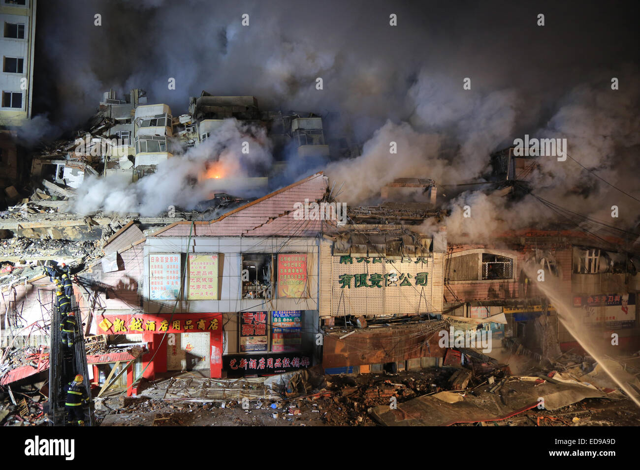 Harbin. 3rd Jan, 2015. Rescuers work on the scene of a warehouse fire ...