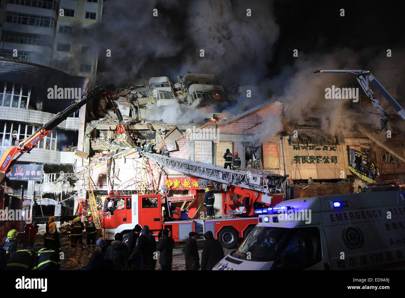 Harbin. 3rd Jan, 2015. Rescuers work on the scene of a warehouse fire ...
