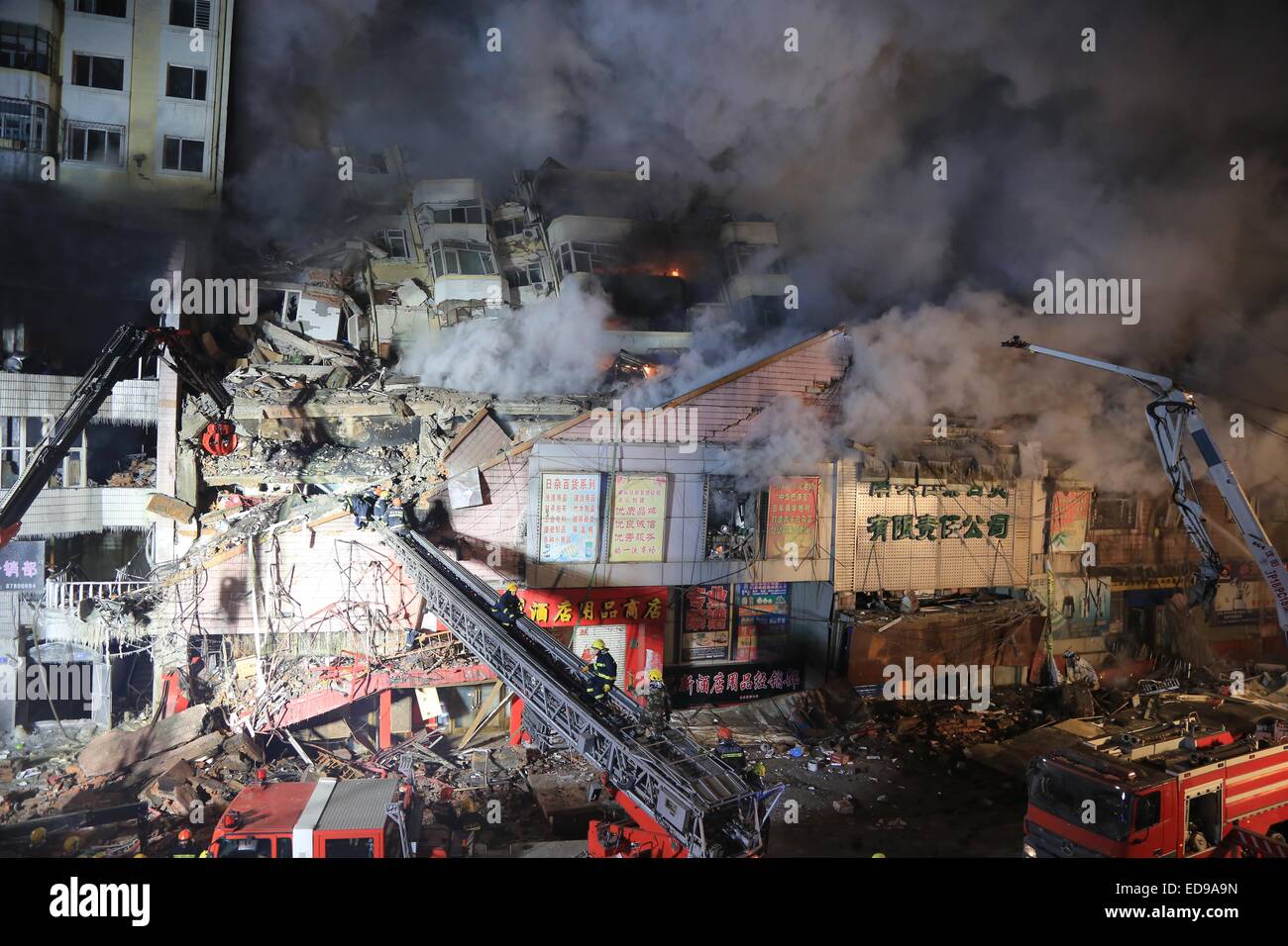 Harbin. 3rd Jan, 2015. Rescuers work on the scene of a warehouse fire ...