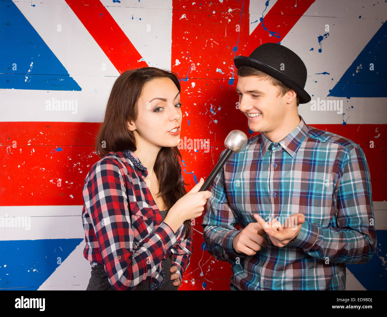 Female British chat show host interviewing a handsome young man in a ...