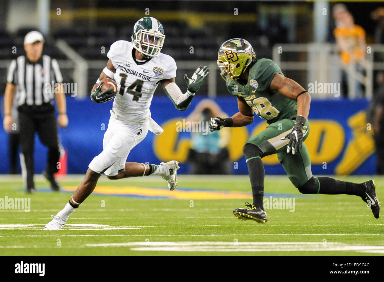 Michigan State receiver Tony Lippett (14) prepares to stiff arm Baylor ...