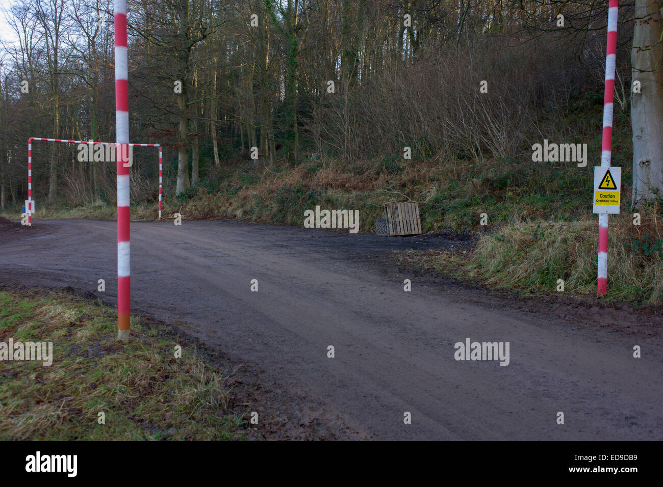 Height restriction caution sign and poles in a north Somerset woodland ...