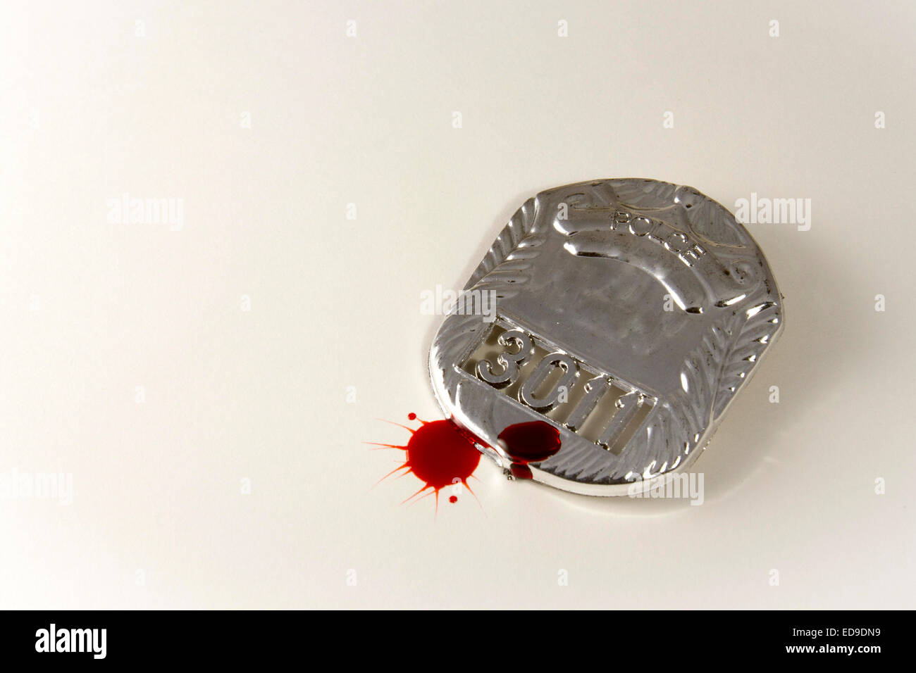 Blood splatter on police badge hi-res stock photography and images - Alamy
