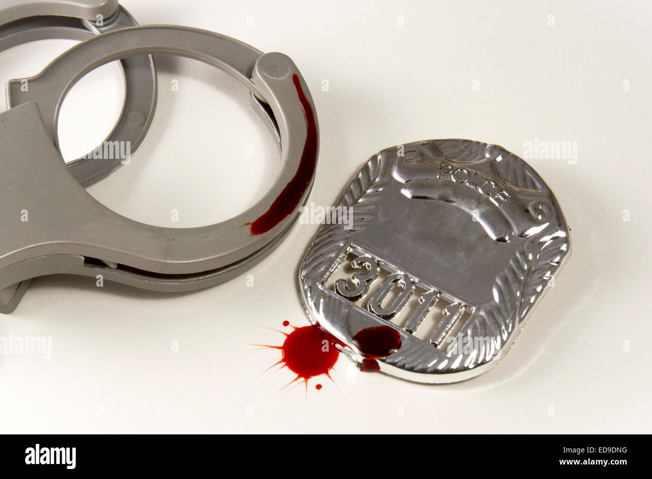Bloody badge and handcuffs Stock Photo - Alamy