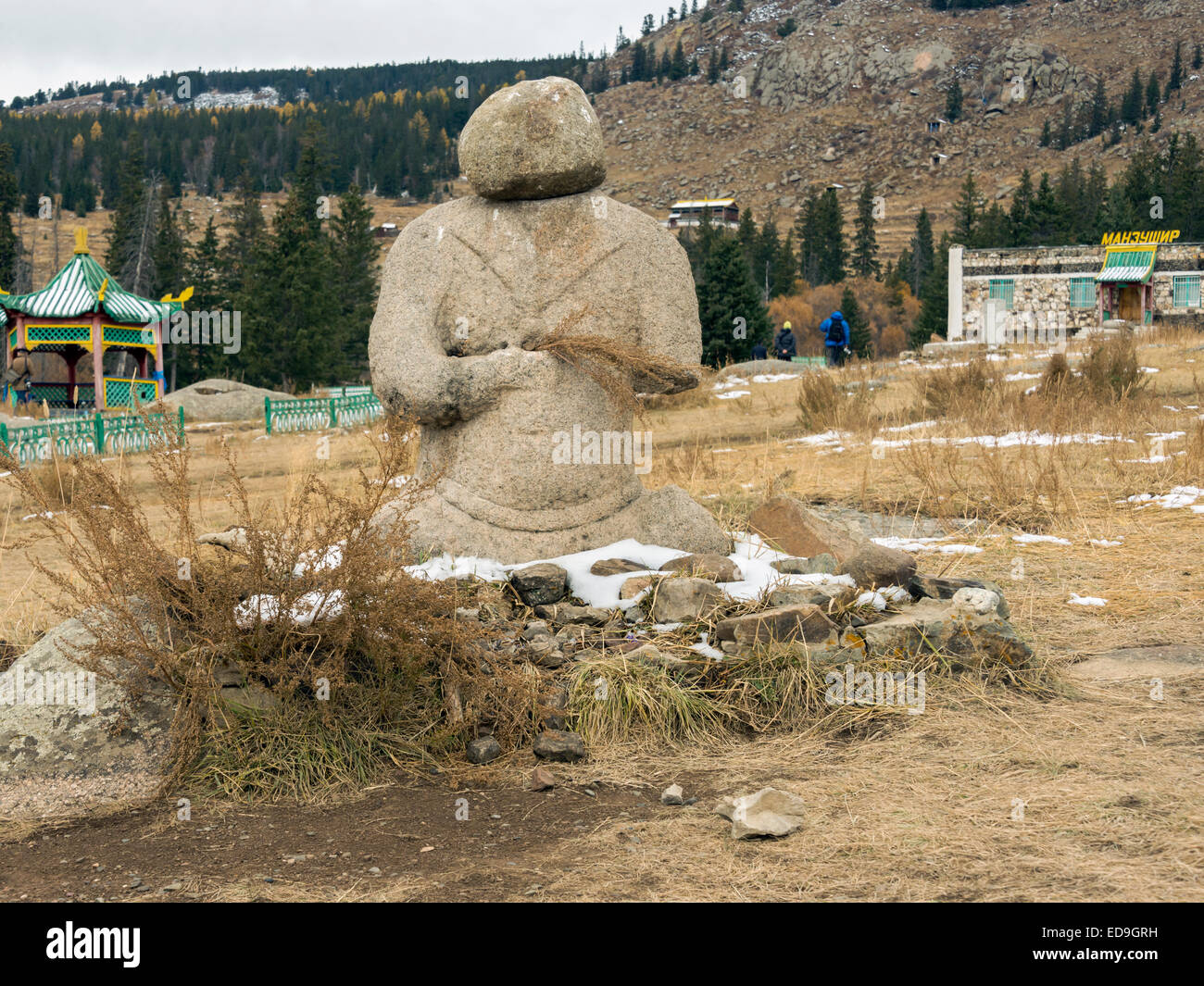 Old stone buddha carving with dried offerings, Manzushir Monastery ...