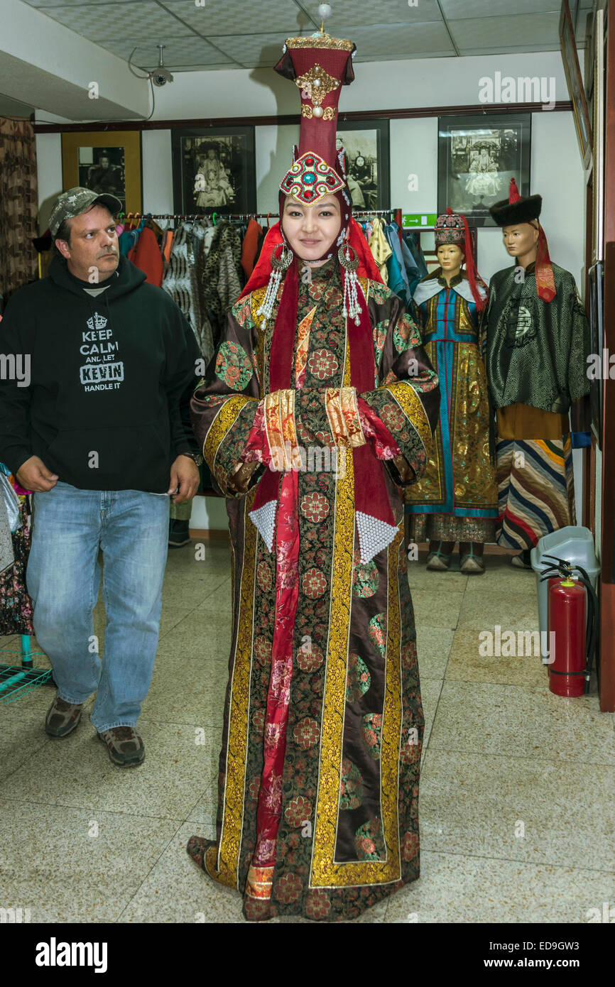 Model in a costume shop wearing the traditional attire of a Mongolian ...