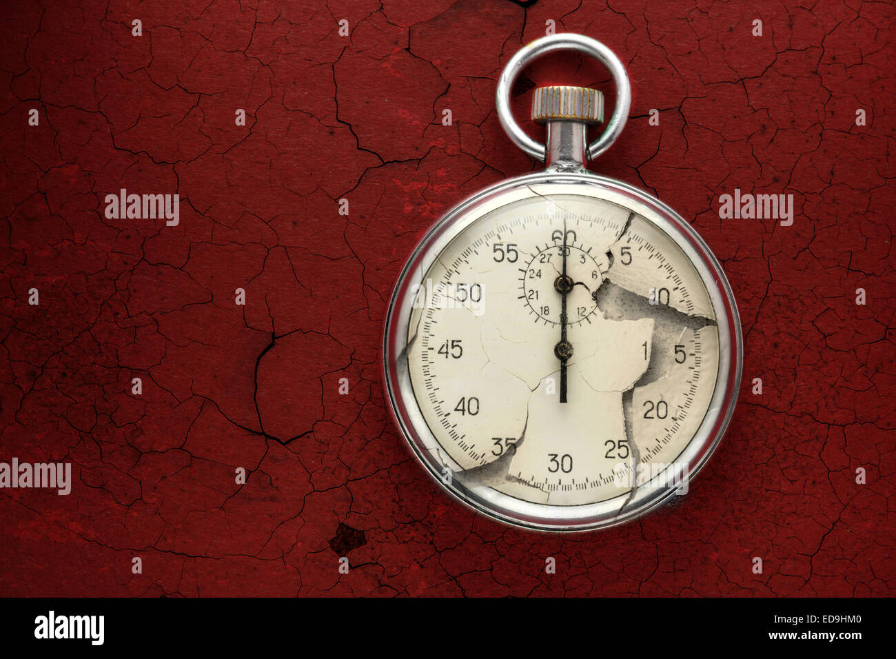 Single stopwatch closeup on red cracked background Stock Photo - Alamy