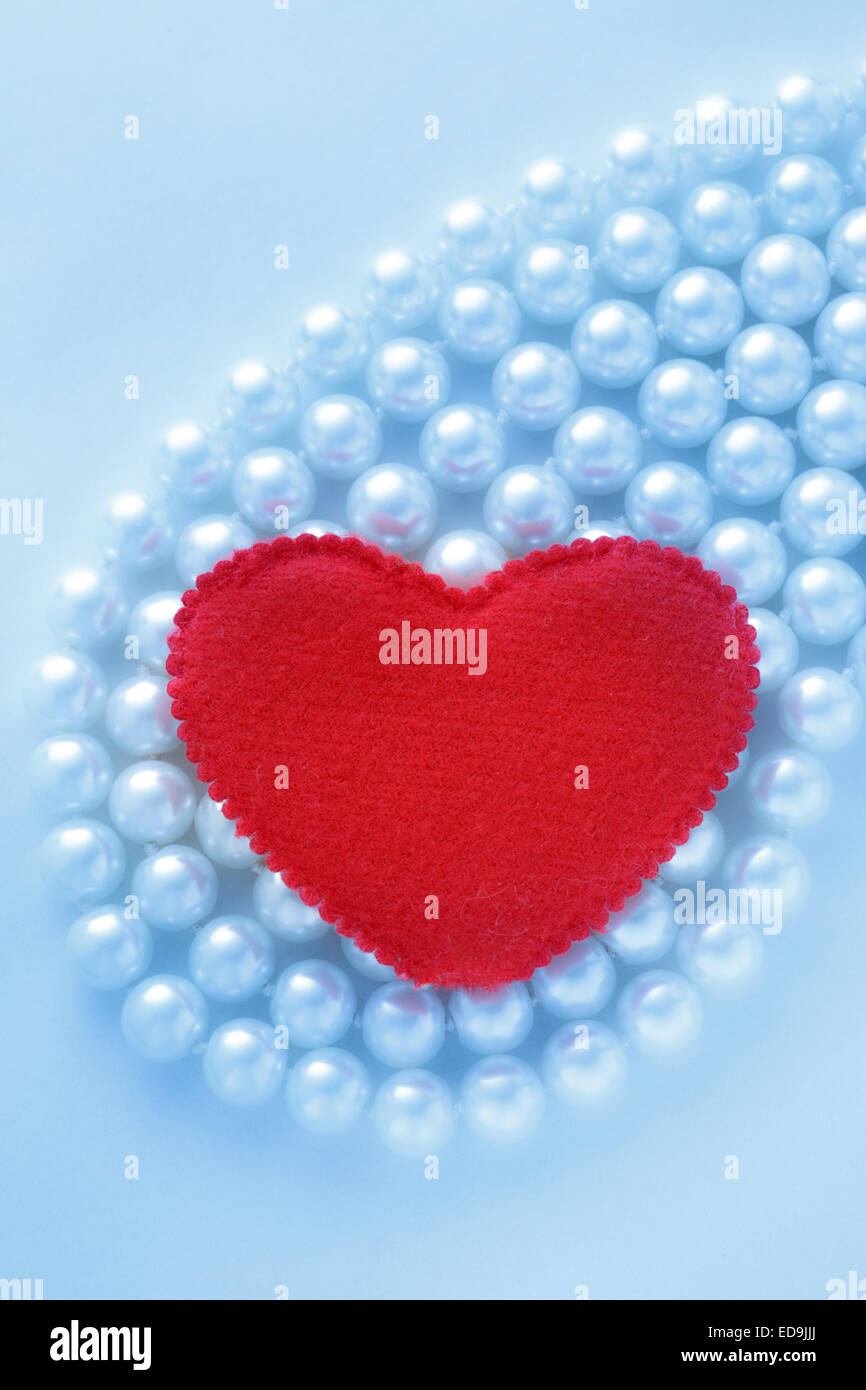 Pearl necklace with heart in closeup on paper background Stock Photo ...