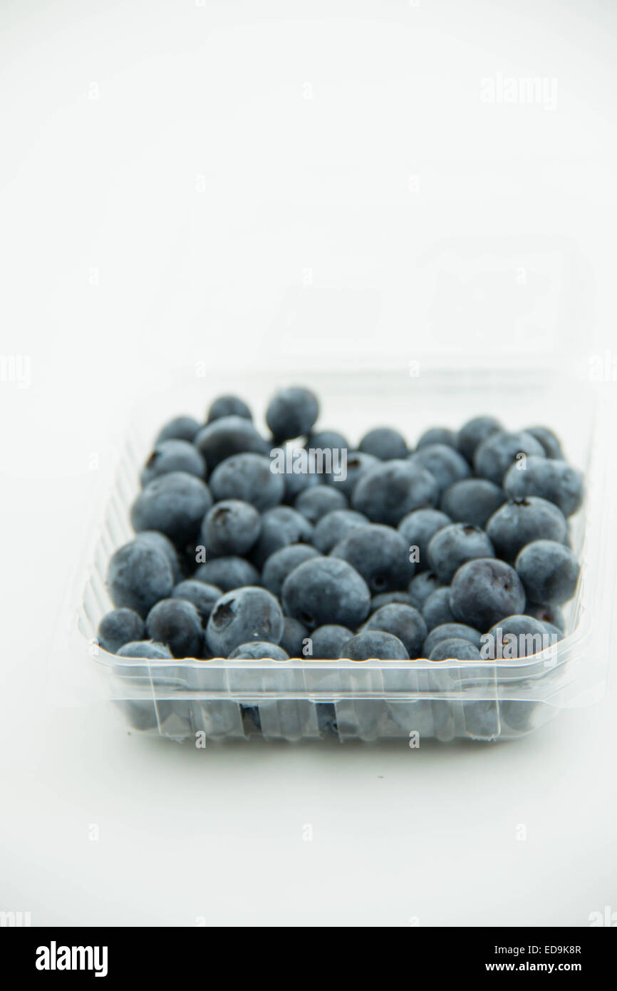 A Blueberry fruit in plastic pack on white background Stock Photo - Alamy