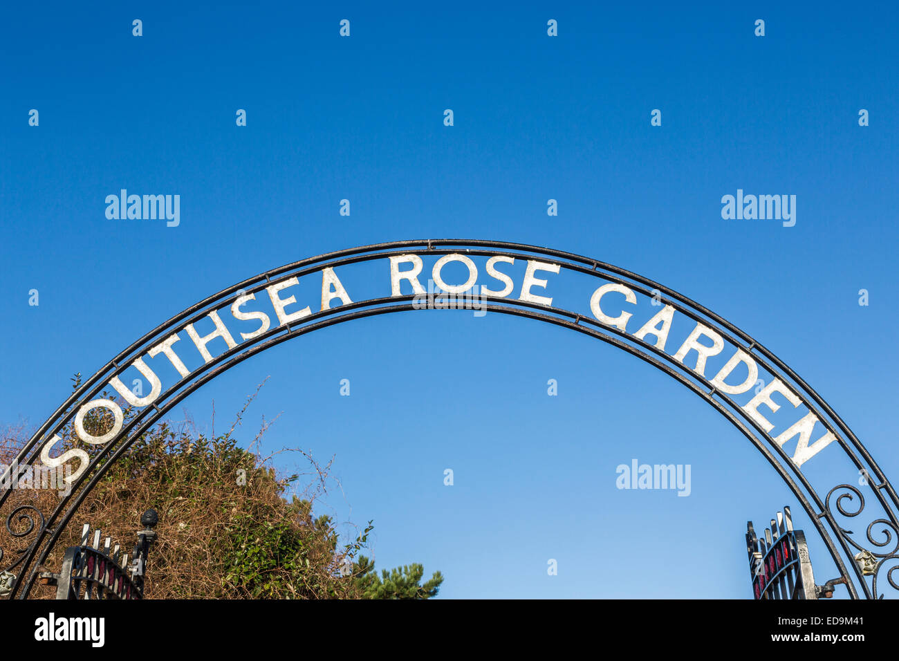 Entrance arch sign at the public Southsea Rose Garden against a blue ...