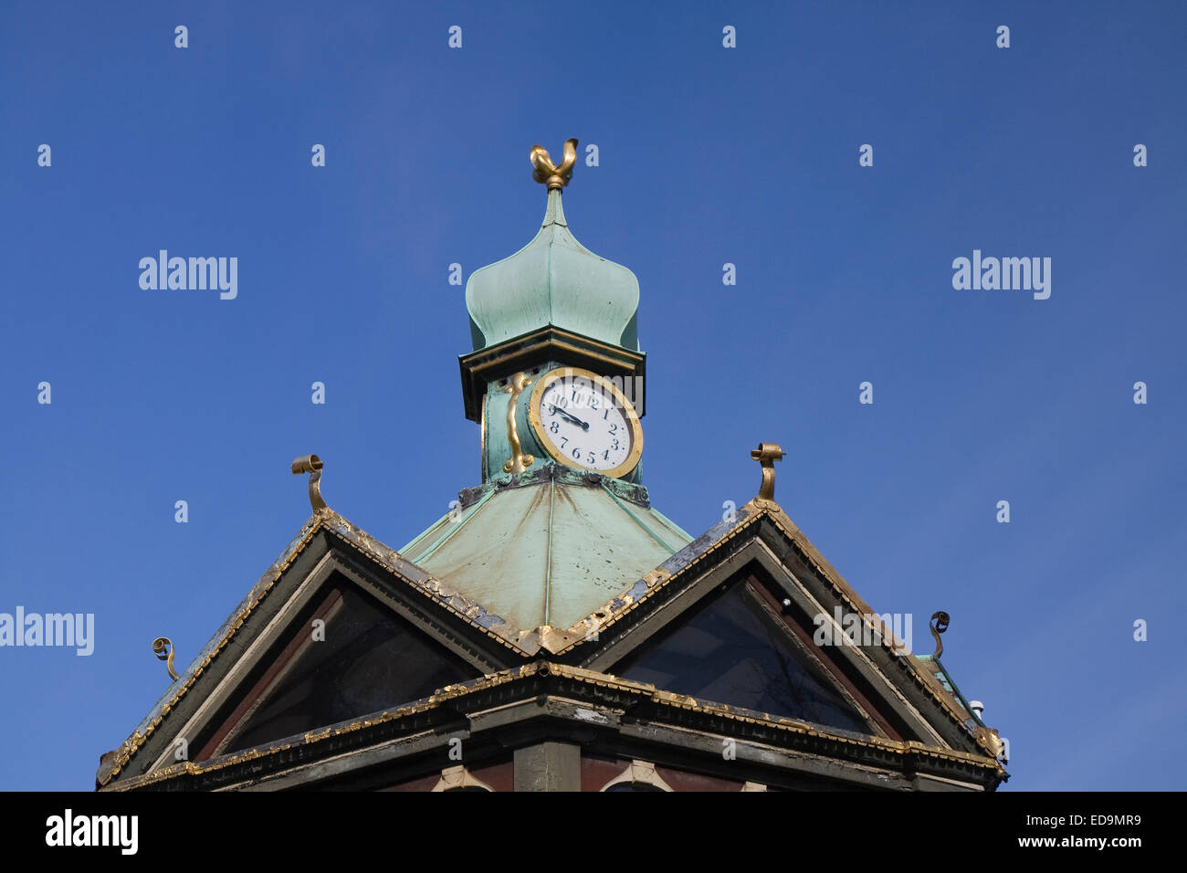 Clock in a small tower with copper roof Stock Photo - Alamy
