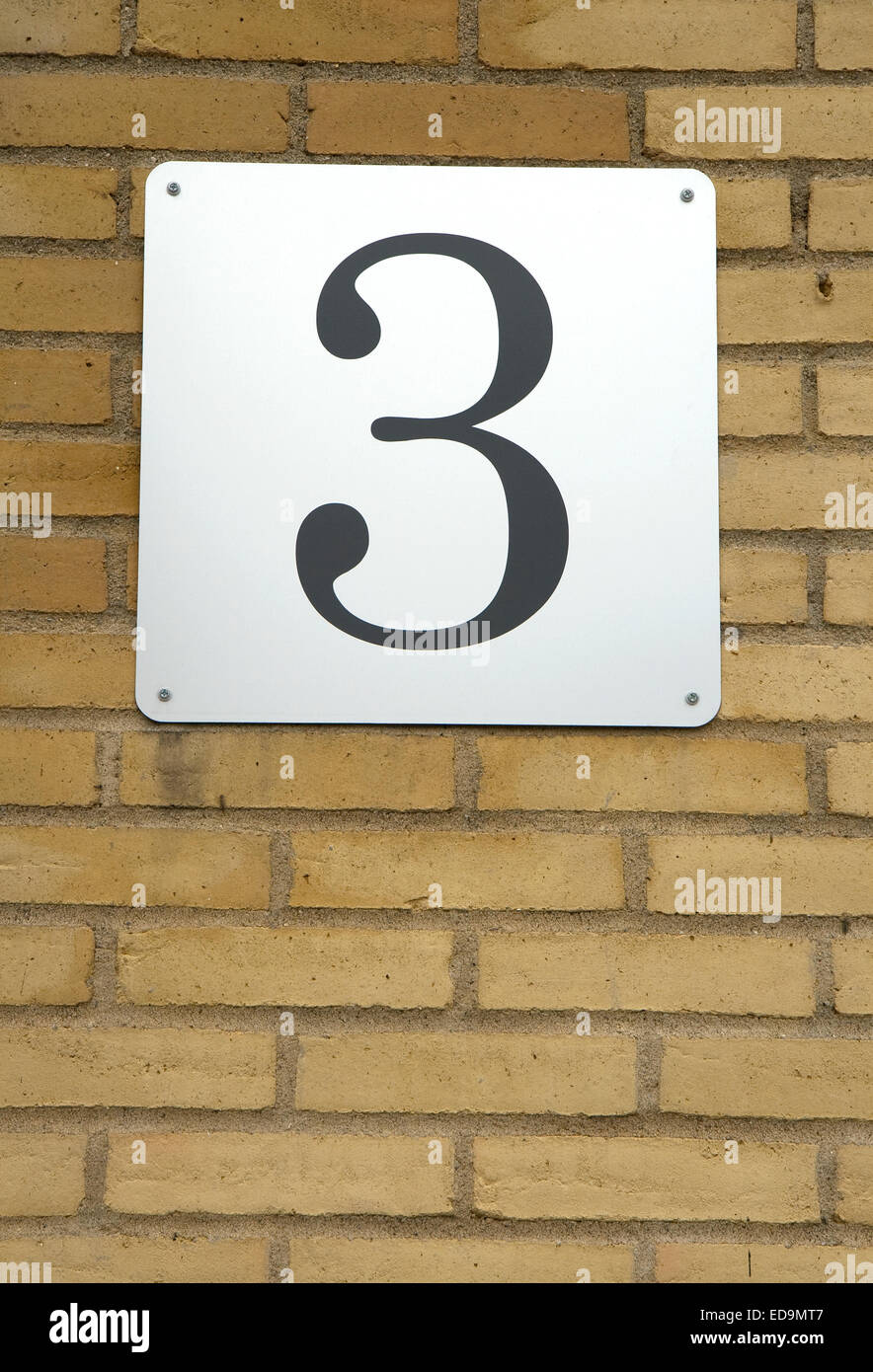 Number 3 on a yellow brick wall Stock Photo - Alamy