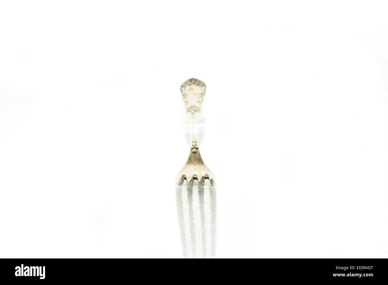Fork with reflection on white glass Stock Photo - Alamy