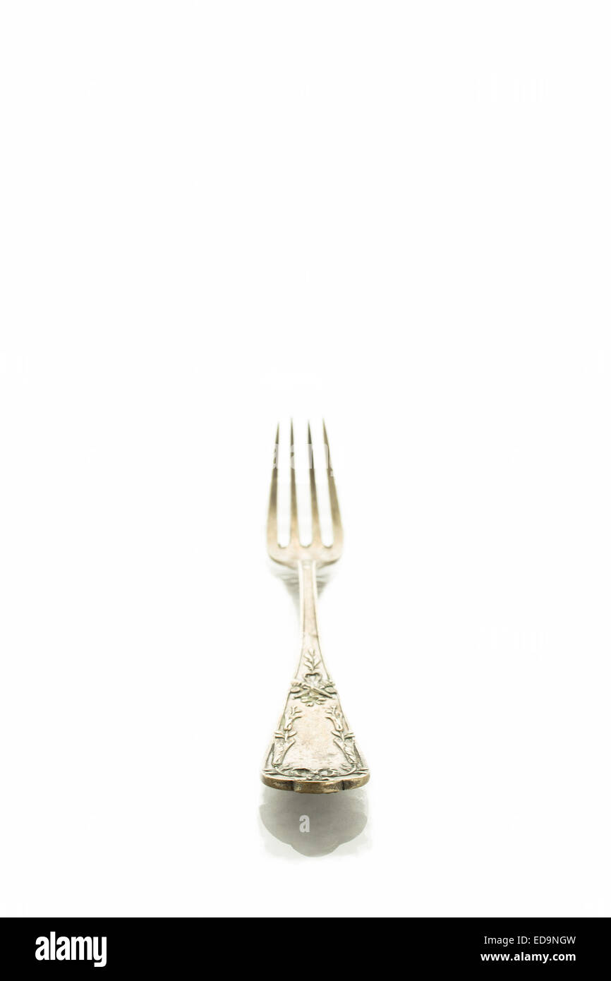 Silver fork in vertical format with text space Stock Photo - Alamy