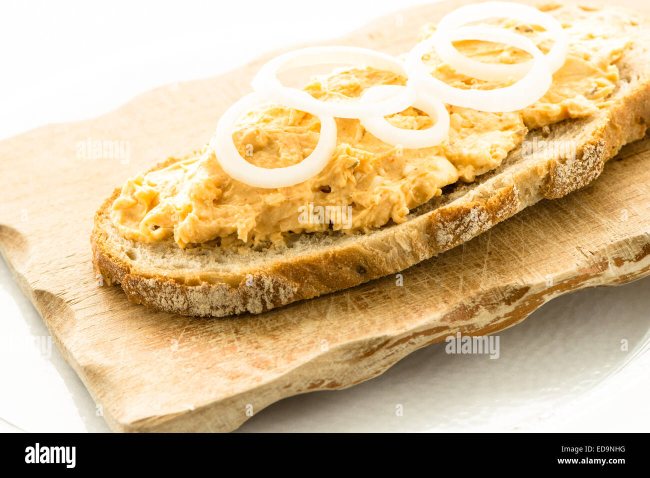 Bread with cheese obatzter and onions on a wooden board Stock Photo - Alamy