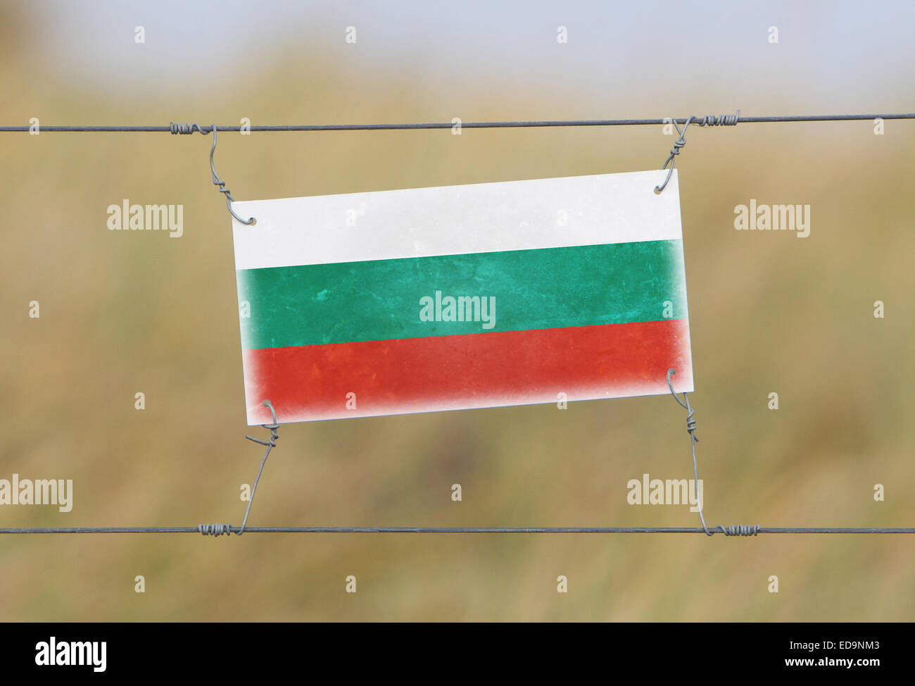 Border fence - Old plastic sign with a flag - Bulgaria Stock Photo - Alamy