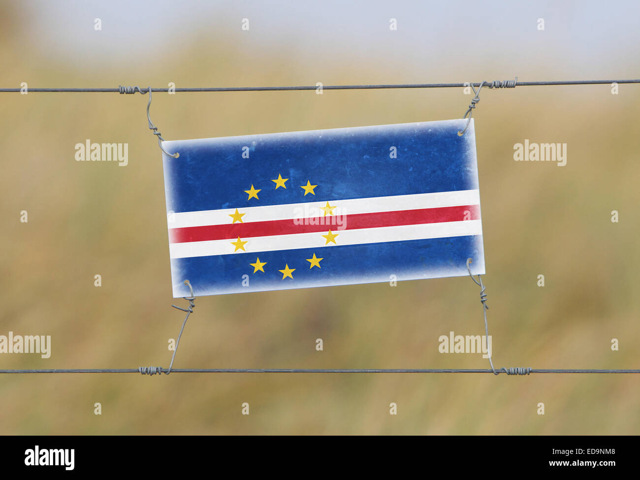 Border fence - Old plastic sign with a flag - Cape Verde Stock Photo ...