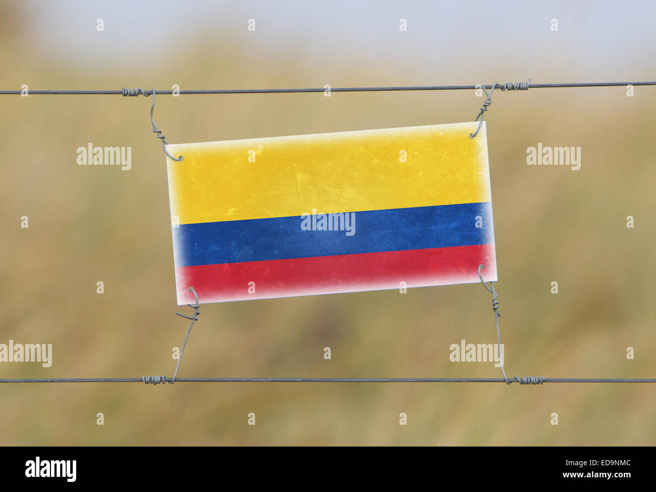 Border fence - Old plastic sign with a flag - Colombia Stock Photo - Alamy