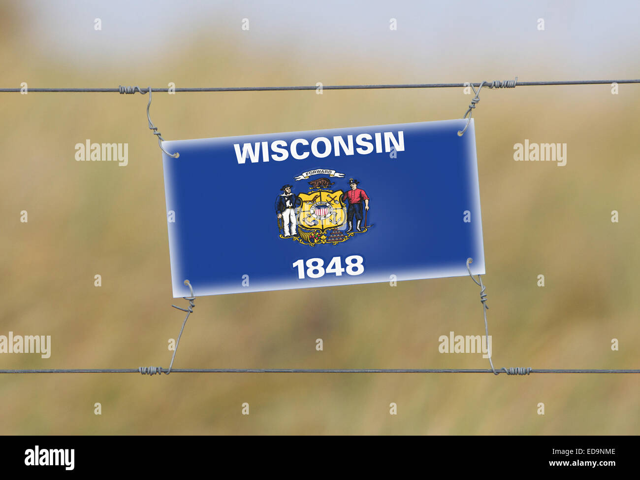 Border fence - Old plastic sign with a flag - Wisconsin Stock Photo - Alamy