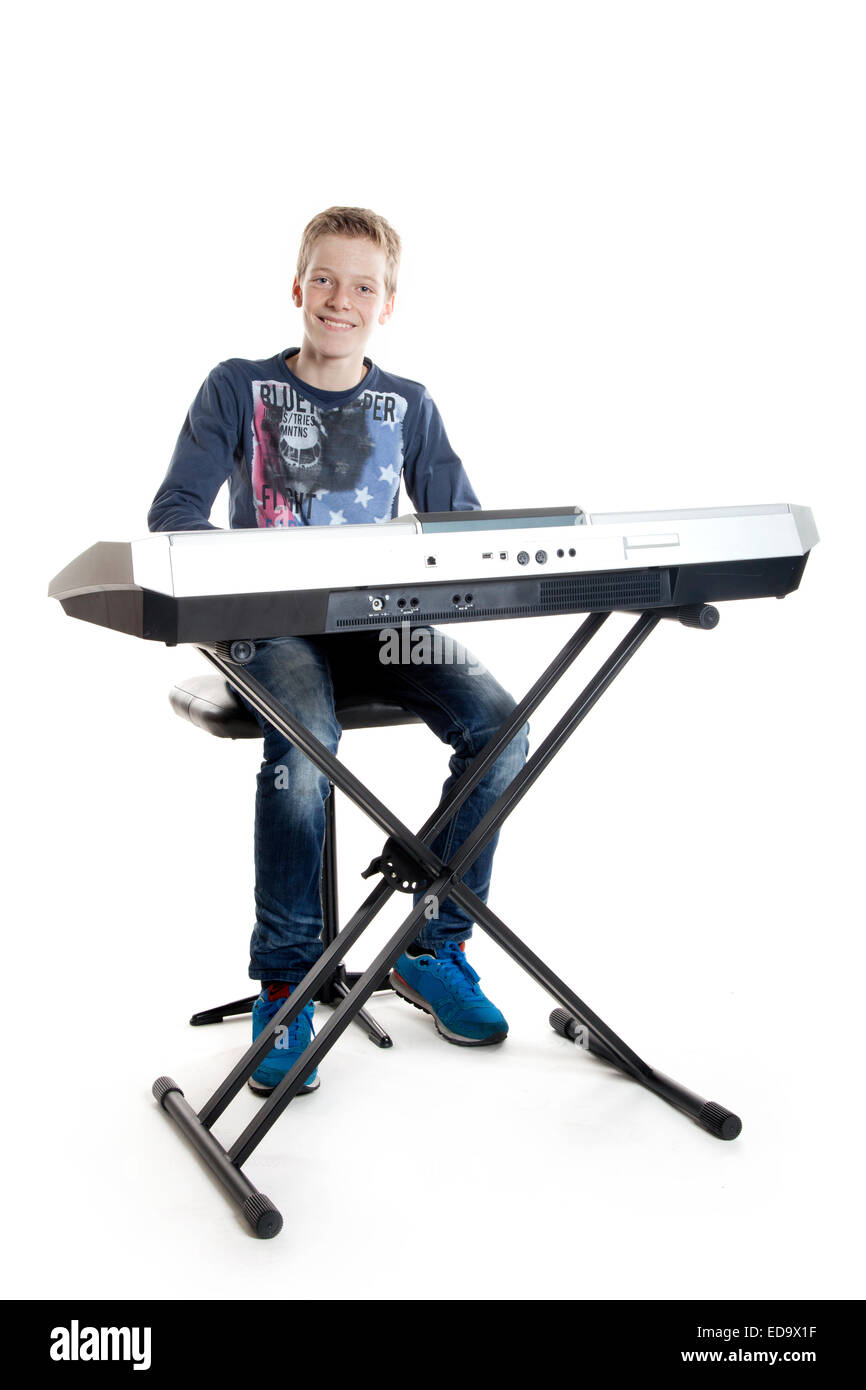 teenage boy sitting at keyboard playing music Stock Photo - Alamy