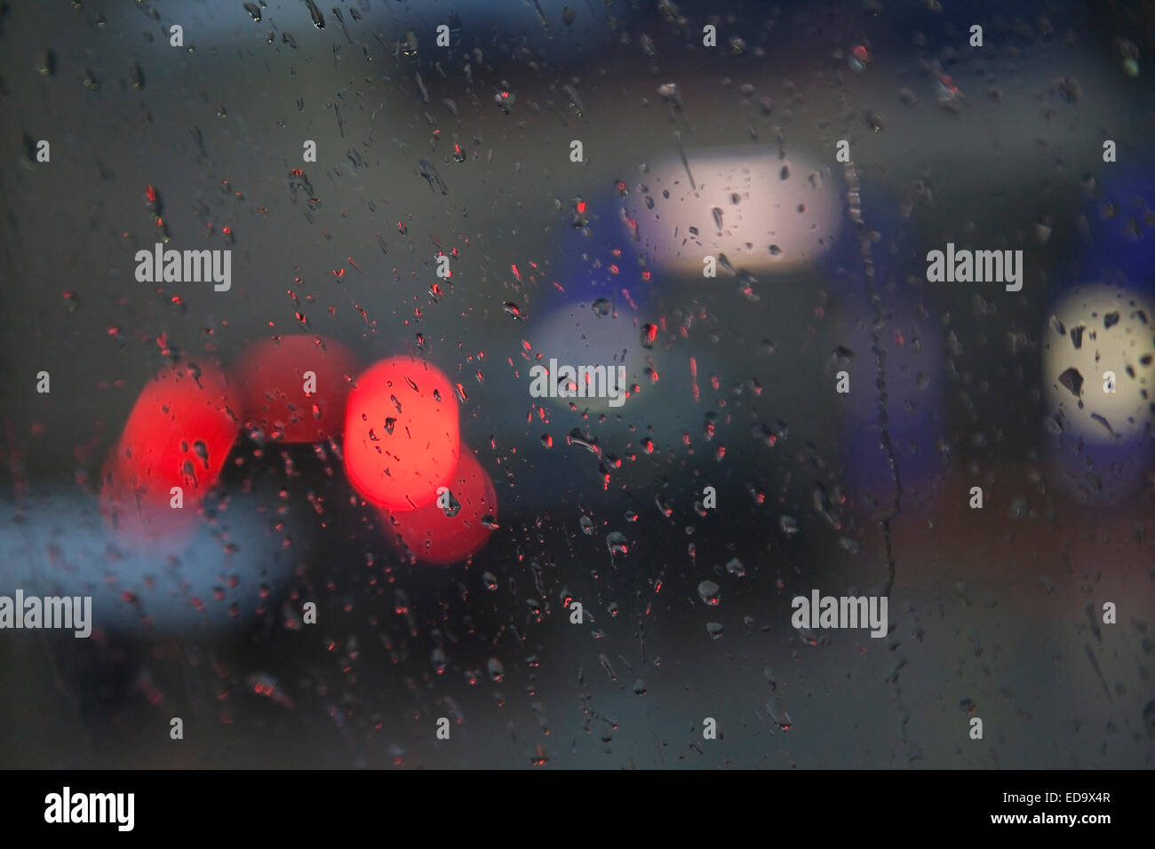 red lights of traffic seen through wet windshield during rainfall Stock ...