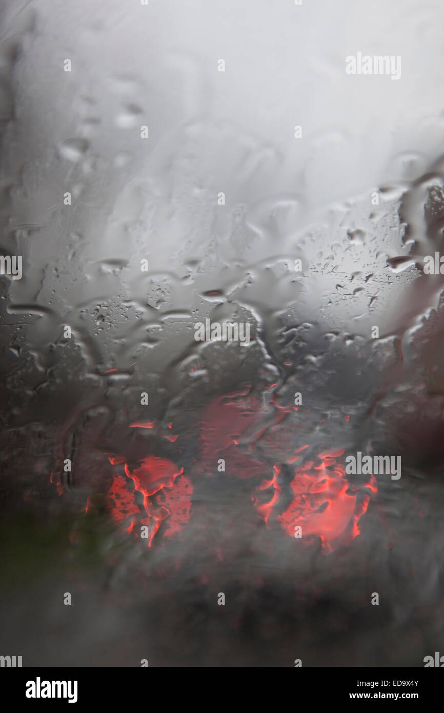 red lights of traffic seen through wet windshield during rainfall Stock ...