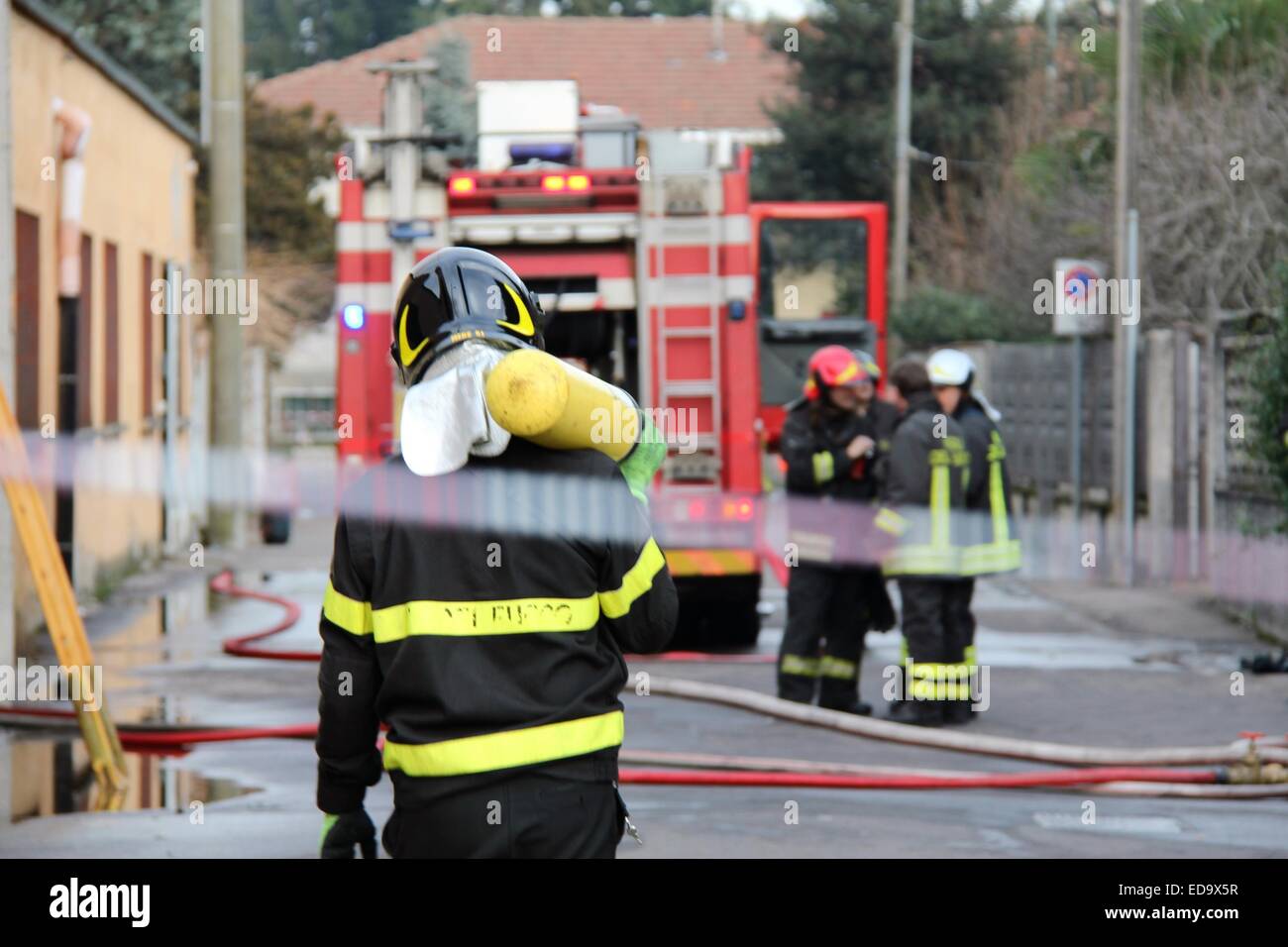 Fireman in action during the fire Stock Photo - Alamy
