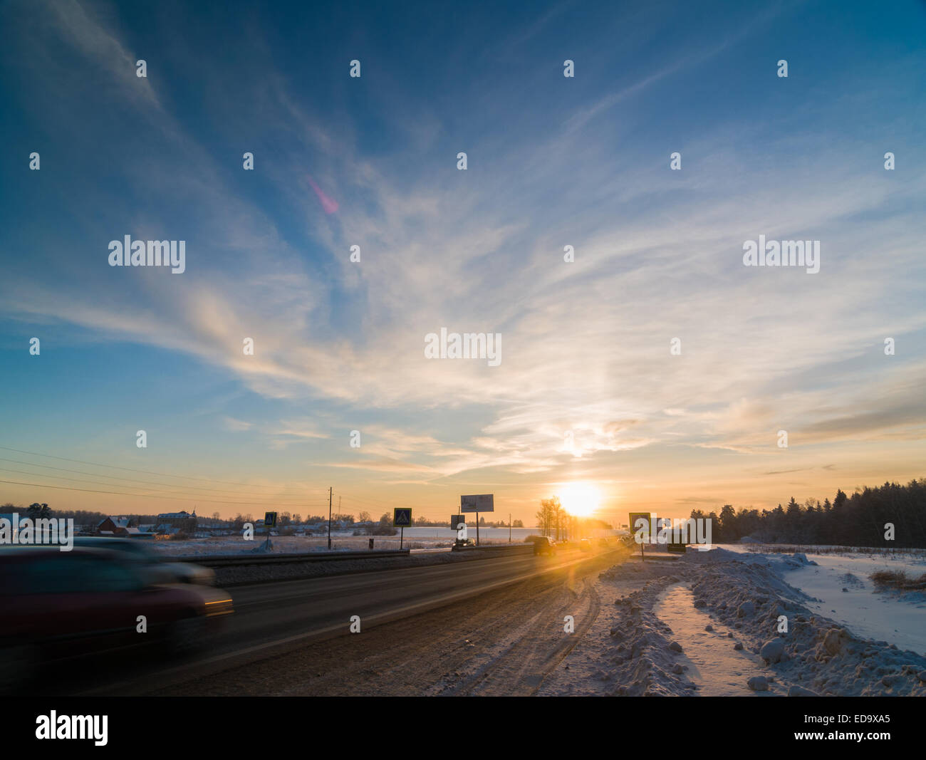 Winter road and sunset sky Stock Photo - Alamy