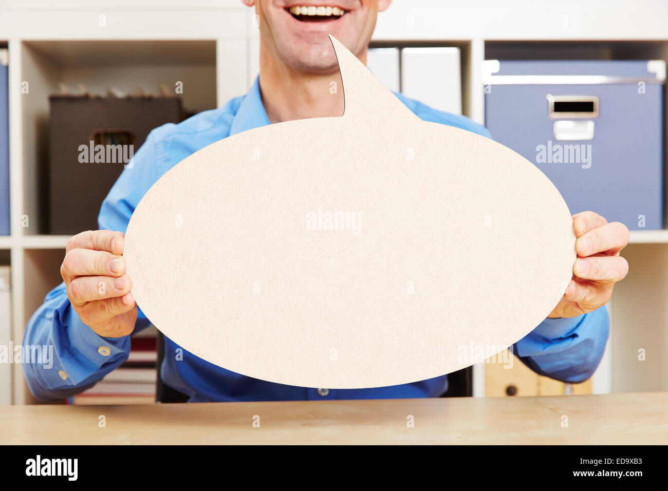 Man talking with big empty speech bubble in his office Stock Photo - Alamy