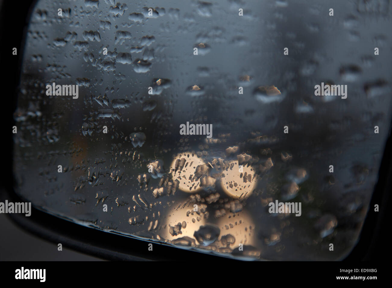 drops on rear view mirror of car and reflections of car lights Stock ...