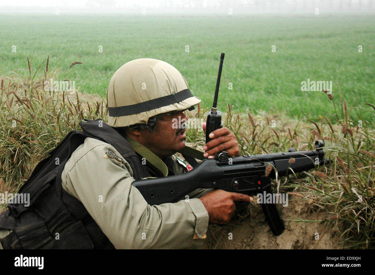 Lahore. 3rd Jan, 2015. A Pakistani ranger talks on wireless as he ...