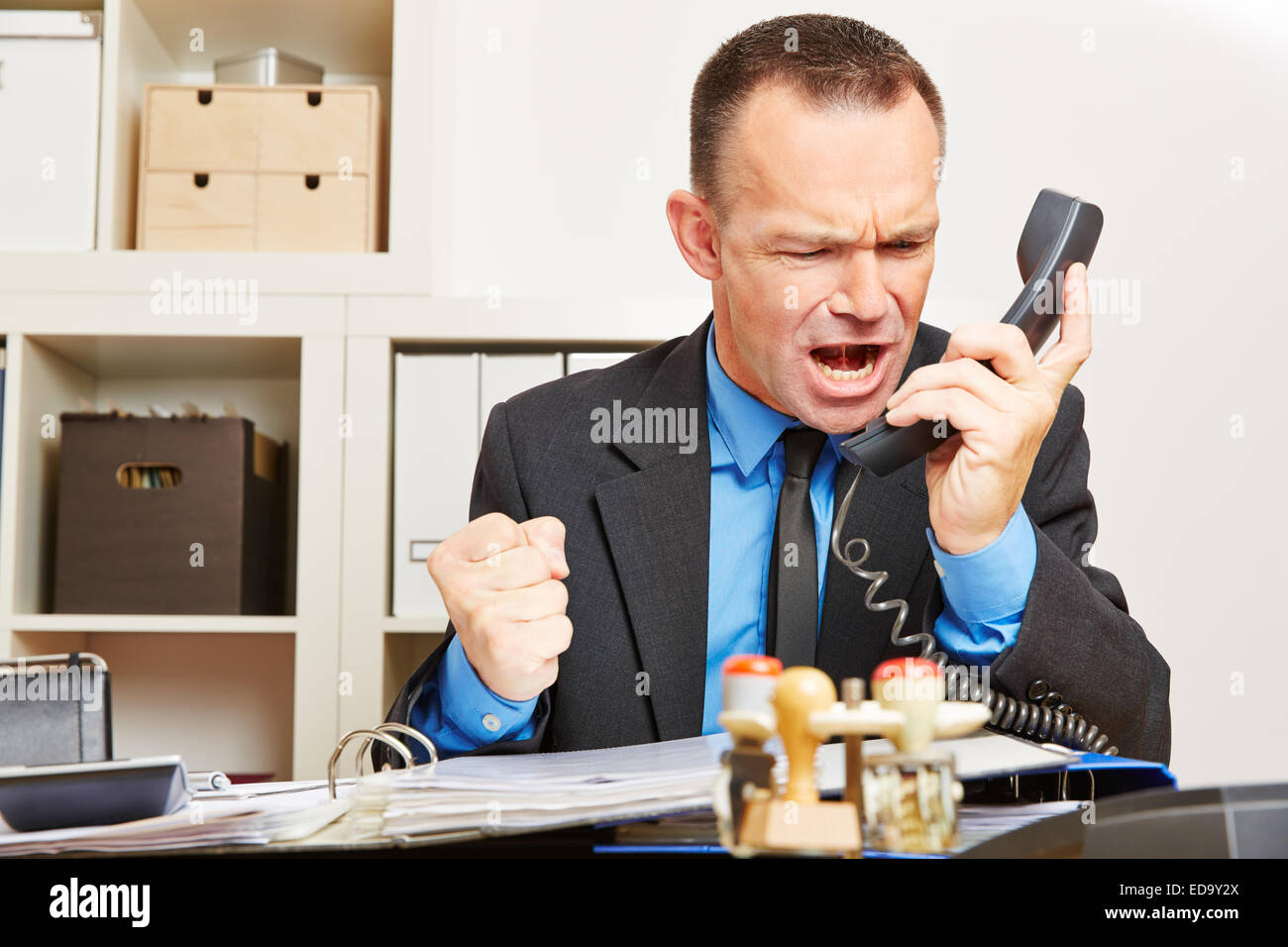 Angry business man screaming at phone in his office Stock Photo - Alamy