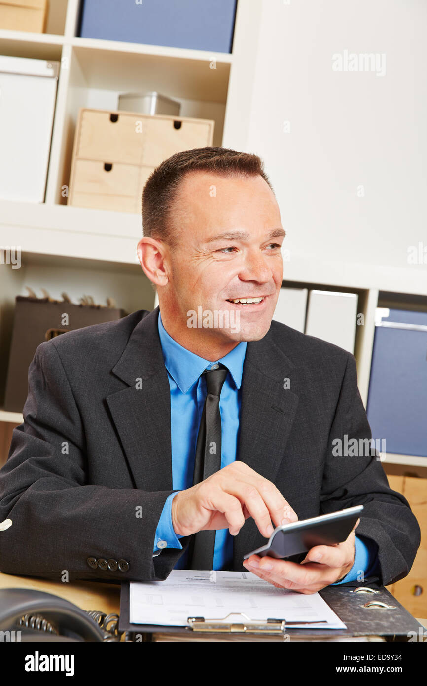 Financial advisor calculating insurance in the office with a calculator ...
